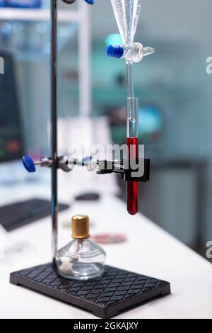 Chemical dripping pipe with test tube in science laboratory at clinic ...