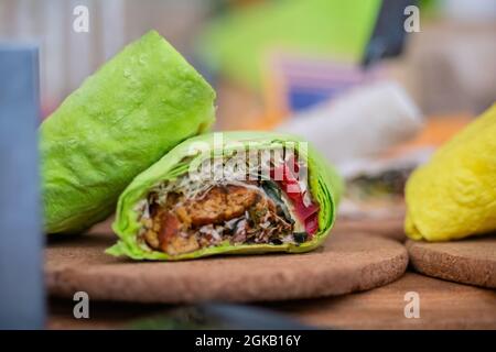 Fresh colorful vegan doner rolls with vegetables on counter at summer ...