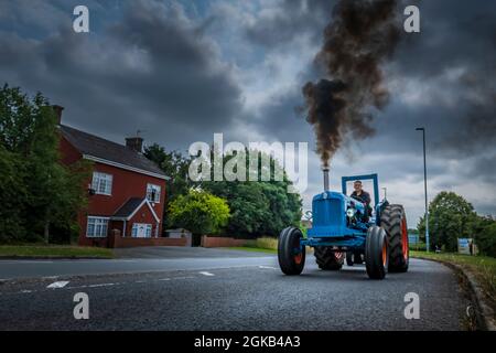 An old tractor belches smoke under full power Stock Photo - Alamy