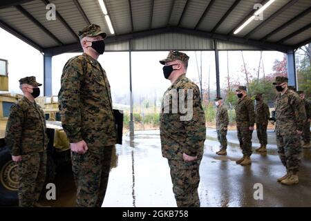 U.S. Marine Col. Todd Manyx, right, passes a guidon to Col. Rory Kent ...