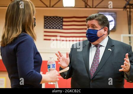 Illinois Governor JB Pritzker, left, greets supporters as he enters the ...