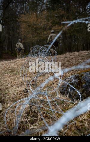 U.S. soldiers set up concertina wire as a customs and border protection ...