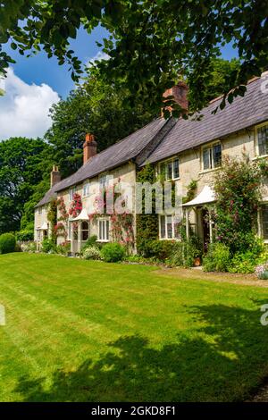 A row of rose covered cottages on the Stourhead estate Wiltshire ...