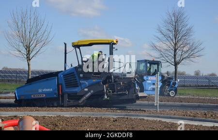 A contractor with Belgian construction firm WANTY lifts a concrete ...