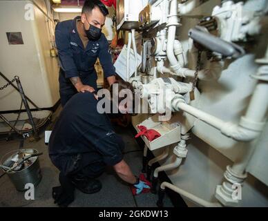 Damage Controlman 2nd Class Shane Rutherford practices using a portable ...