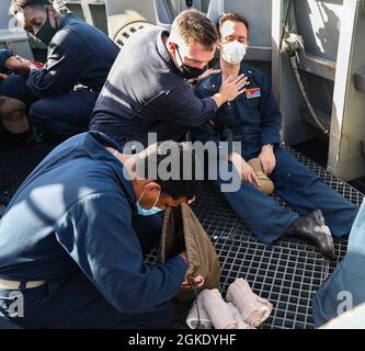 Crew members aboard the guided missile cruiser USS JOSEPHUS DANIELS (CG ...