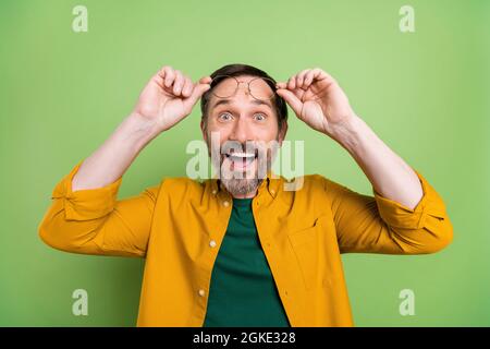 Photo of impressed mature brunet man thumb up wear red t-shirt isolated ...