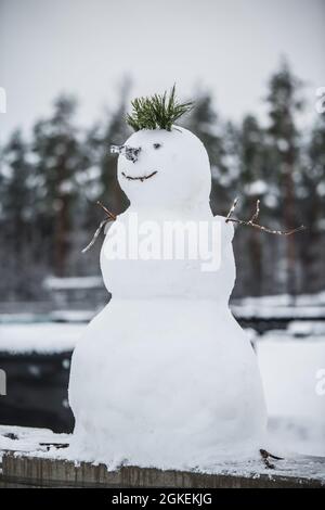 Beautiful snowman. Making a snowman. The first snow in Europe. Making a ...