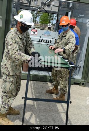 Two Seabees from Naval Mobile Cosntruction Battalion 4 (NMCB-4) signal ...