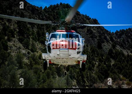 U.S. Navy search and rescue (SAR) swimmers signal to a boat captain ...