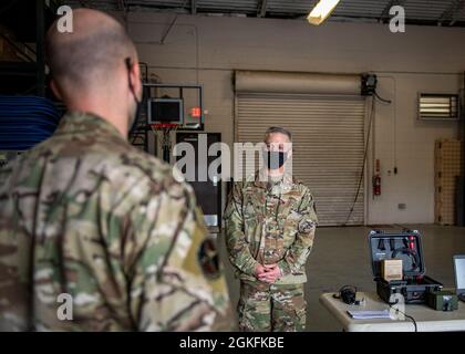 Lt. Gen. Timothy Haugh, left, 16th Air Force commander, applauds with ...