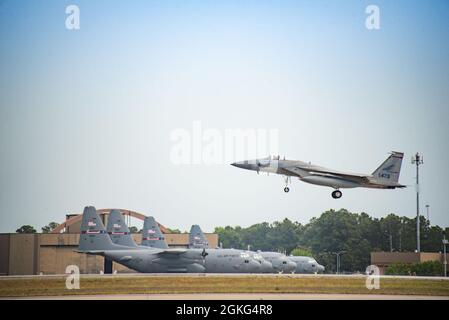 A C-130 Hercules aircraft passes over an assault airstrip to make a low ...