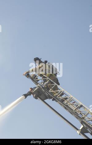 San Diego City (SDFD) firefighter ladders to second floor of a ...