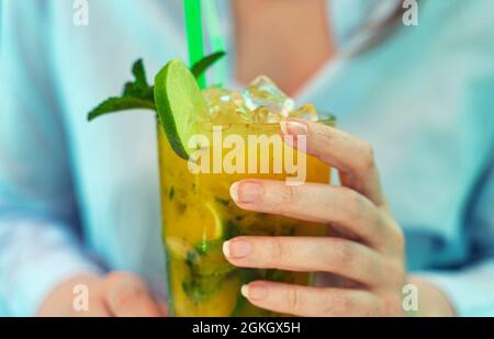 Woman holds delicious handmade lemonade with lime Stock Photo - Alamy