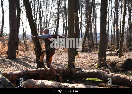 A participant of the Wild Boar Mud Run emerges from part of an obstacle ...