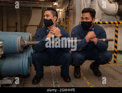 US Navy Aviation Ordnanceman prepare MK-76 practice bombs to be issued ...