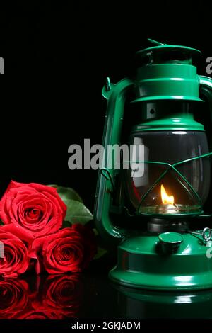 Beautiful roses and retro lamp on dark background Stock Photo - Alamy