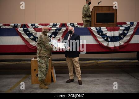 Col. Sean Riley, 102nd Intelligence Wing Commander, hands the ...