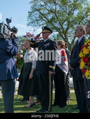 An army officer salutes during a wreath laying ceremony at The Hector ...