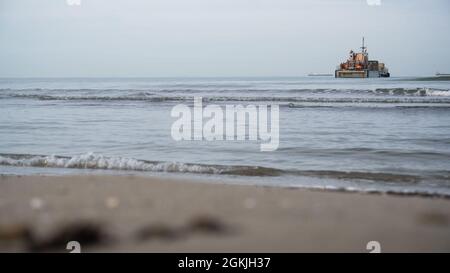 A U.S. Navy Improved Navy Lighterage System Causeway Ferry, prepares to ...