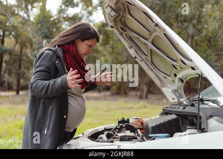 Young pregnant woman opening arms for hug on yellow background. Rules ...