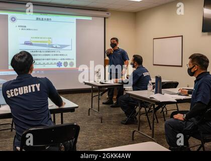 OKINAWA, Japan (May 12, 2021) Rear Adm. Fred Kacher, left, salutes Rear ...