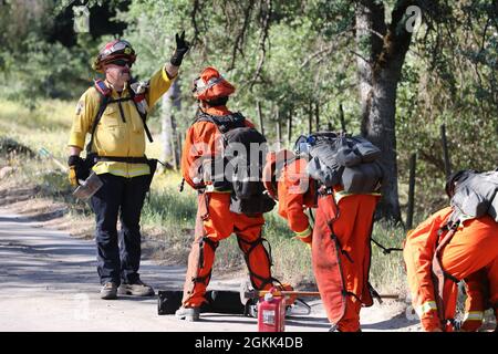 A California Department of Corrections fire crew looks on as the Canyon ...