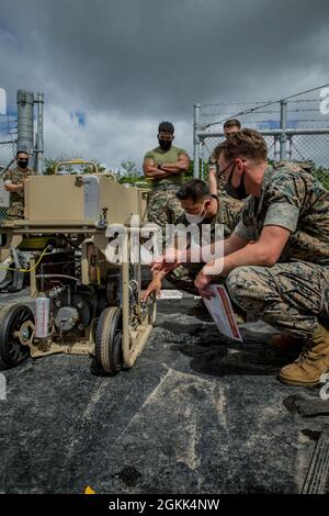 OKINAWA, Japan (May 12, 2021) Rear Adm. Fred Kacher, left, salutes Rear ...