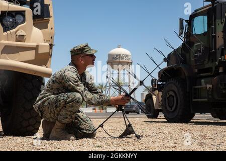 An Air Force radio operator adjusts his pack straps as he pauses with ...