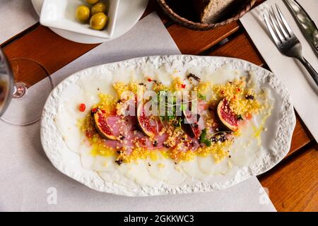 Cod carpaccio with fresh figs Stock Photo - Alamy