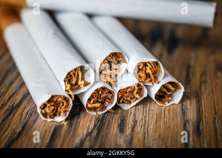 Close up of a hndmade smoking cigarettes on wooden background Stock ...