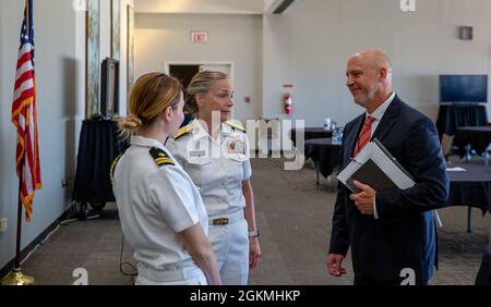 Rear Admiral Sara Joyner (left), Assistant Secretary of the Navy James ...