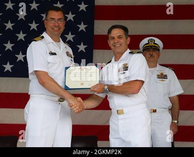 Cmdr. Michael A. Woodcock (left), officer in charge at the Naval ...