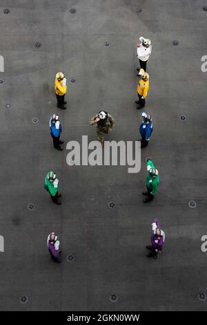 U.S. Navy Vice Admiral Bill Merz, center, commander of 7th Fleet, and ...