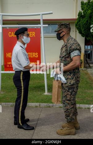 U.S. Marine Corps Col. Omar Randall, left, off-going commanding officer ...