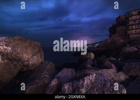 suggestive view through the rocks of the sea in the evening Stock Photo ...