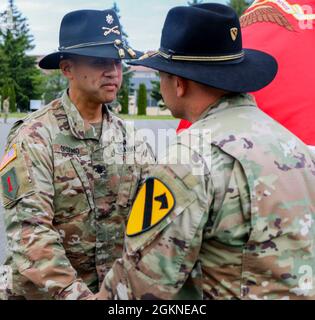 Col. Jon W. Meredith, commander, 1st Armored Brigade Combat Team, hands ...