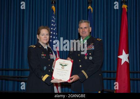 Col. Sam Speedy (right) is presented an award for his service by Gen ...