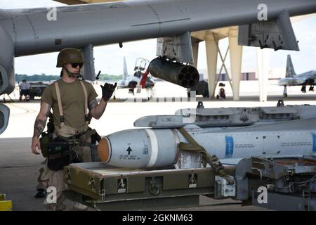Weapons troops from the 442d Munitions Squadron load practice bombs ...