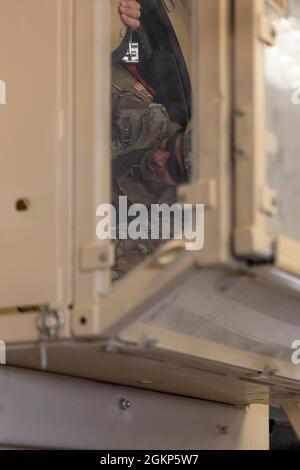 Soldiers inside a vehicle rollover simulator unharness to exit a ...