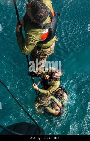 Costa Rican policemen with the Costa Rican police forces swim to a ...