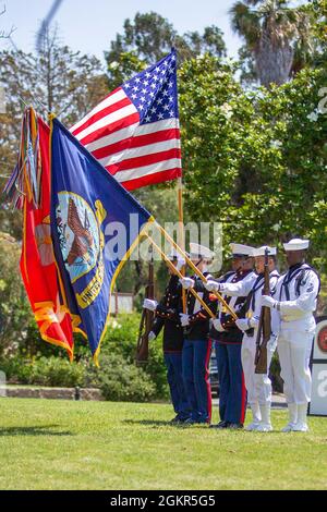 A joint Marine Corps/Navy color guard stands at attention at the ...