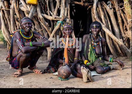 Old woman of the Jiye tribe smoking a pipe, Eastern Equatoria State ...