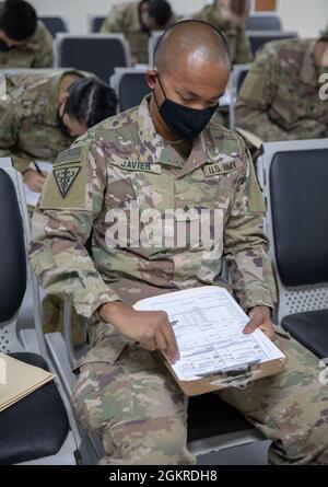 U.S. Army Sgt. Jason Javier (left), a veterinary food noncommissioned ...