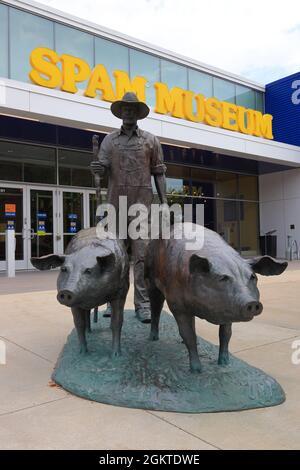 Farmer and pigs statue of Spam Museum with downtown Austin in ...