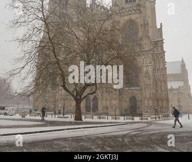 A person walks past York Minster covered in snow, York, UK Stock Photo ...