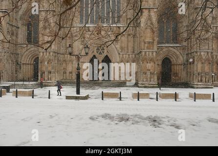 A person walks past York Minster covered in snow, York, UK Stock Photo ...