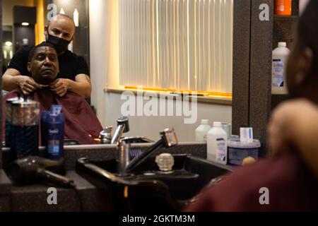 Maj. Gen. Randall Reed, Third Air Force commander, receives a haircut ...