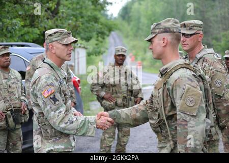 Col. Sean Flynn, commander of the 27th Infantry Brigade Combat Team, speaks with Staff Sgt ...
