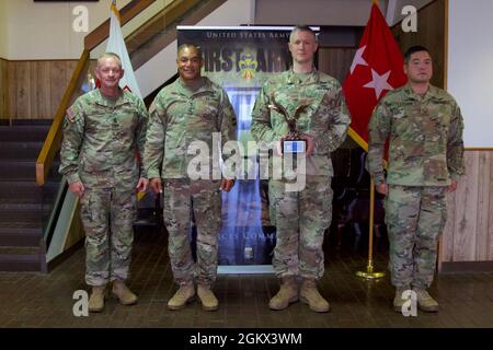 Division Command Sergeant Major Todd Sims congratulates and gives a ...